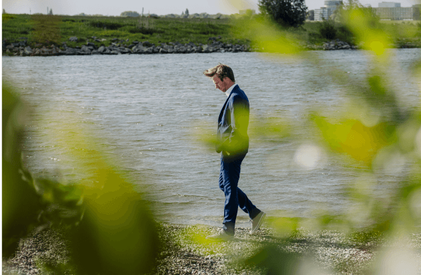 A person walking along a lake